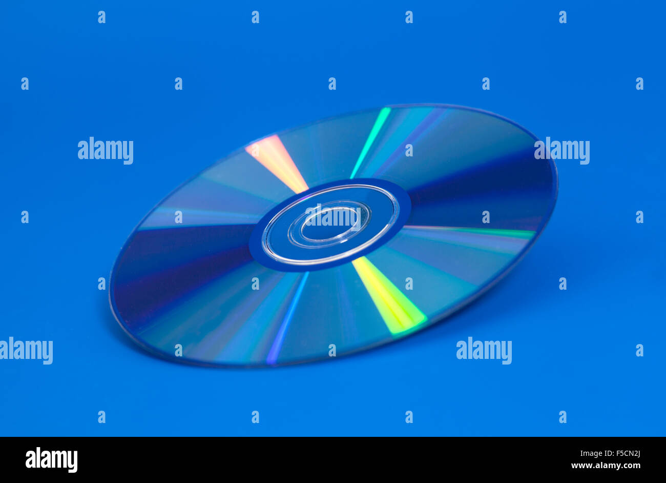 Compact disk on blue background Stock Photo - Alamy