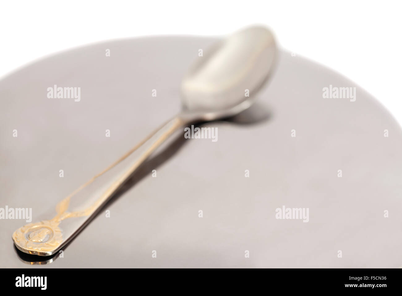 Chrome spoon on white background Stock Photo - Alamy