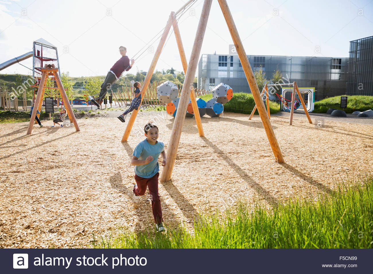 Boy running at sunny playground Stock Photo: 89405269 - Alamy
