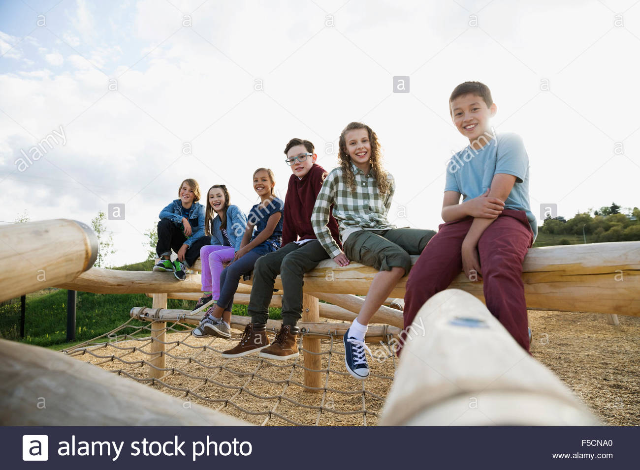 Smiling child sitting on log hi-res stock photography and images - Alamy