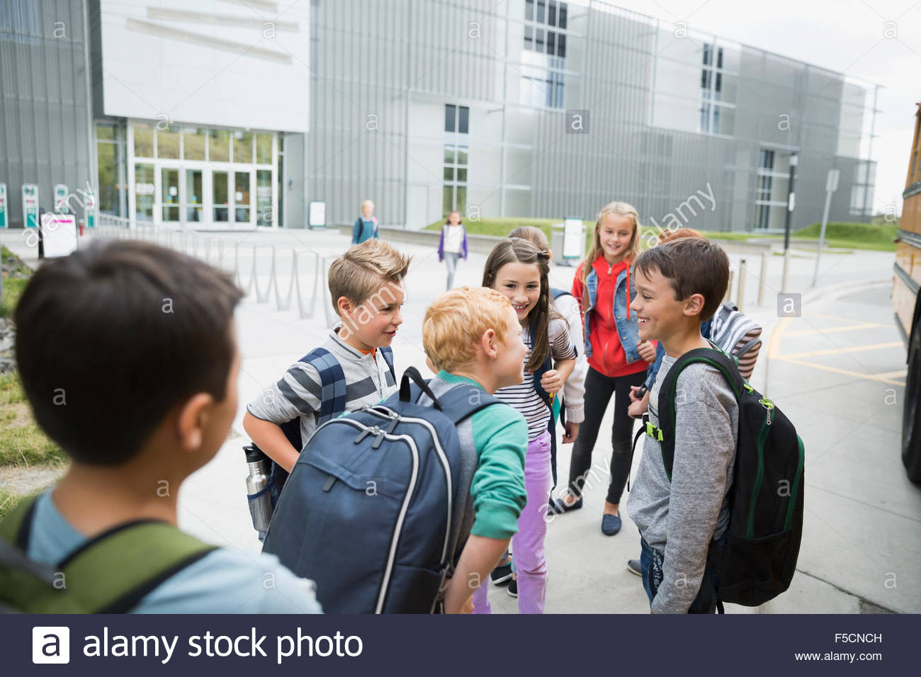 Three kids talking outside hi-res stock photography and images - Alamy