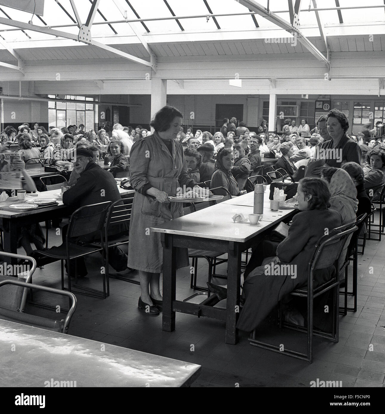 1950s historical picture of factory workers taking a break from work in ...