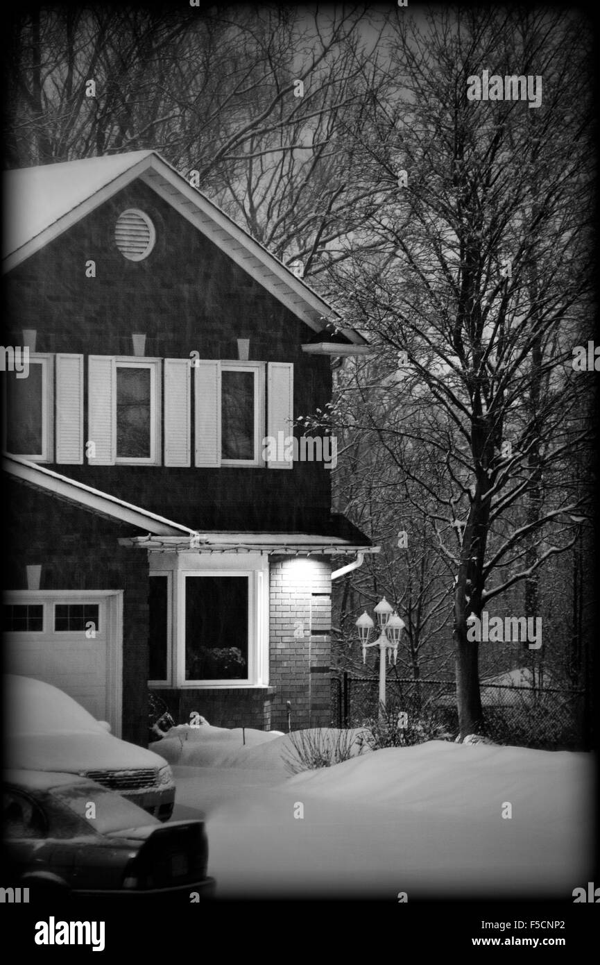 Front yard of a two-storey house covered with snow in Toronto suburbs ...