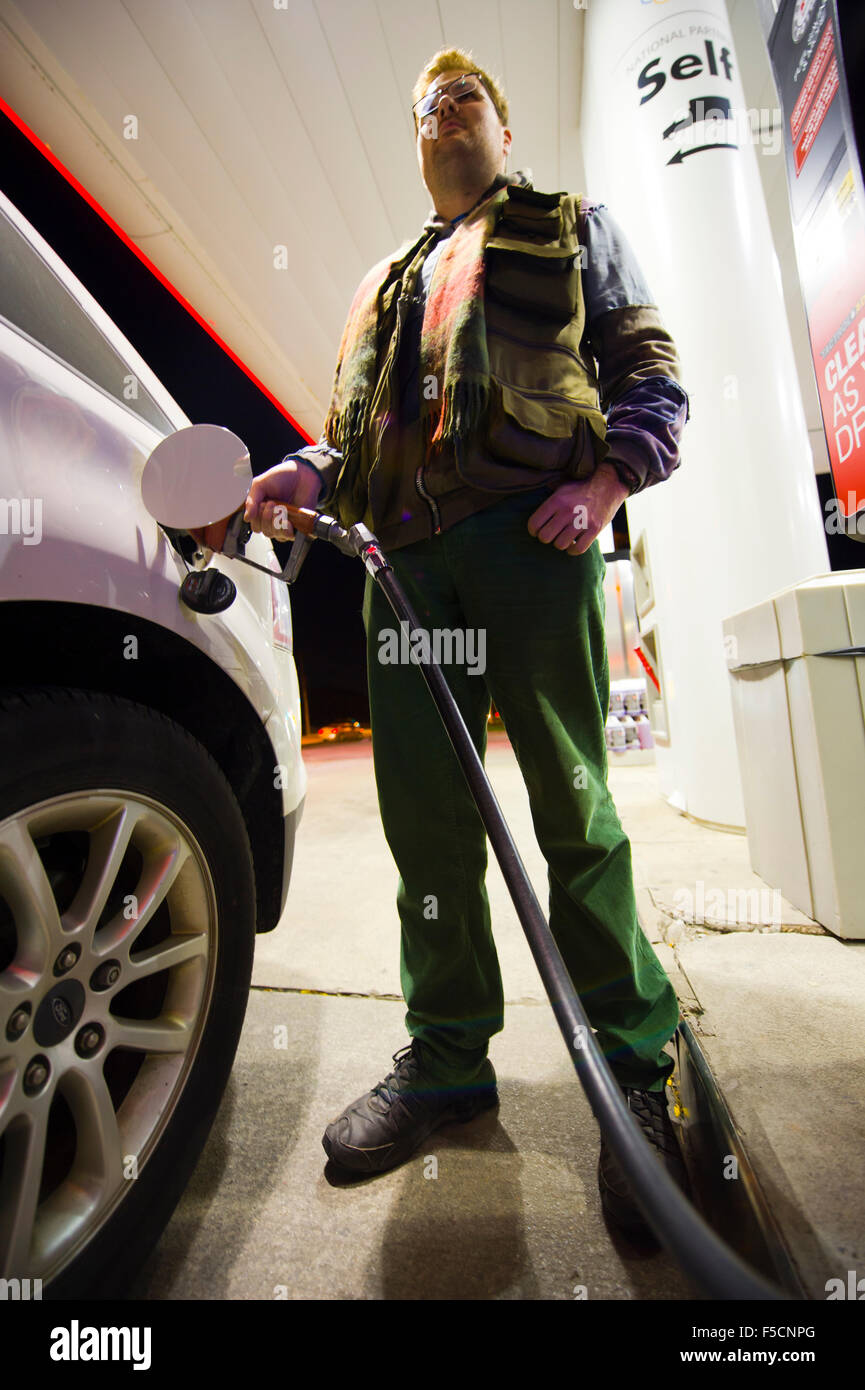 young man filling in the car tank at a gas station Stock Photo - Alamy
