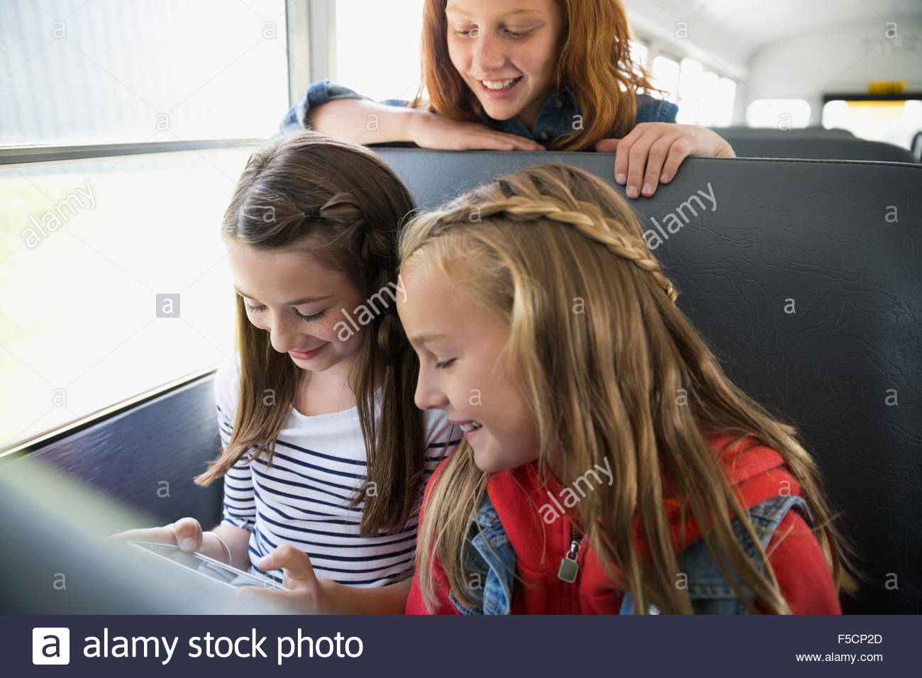 School girl on bus on phone hi-res stock photography and images - Alamy