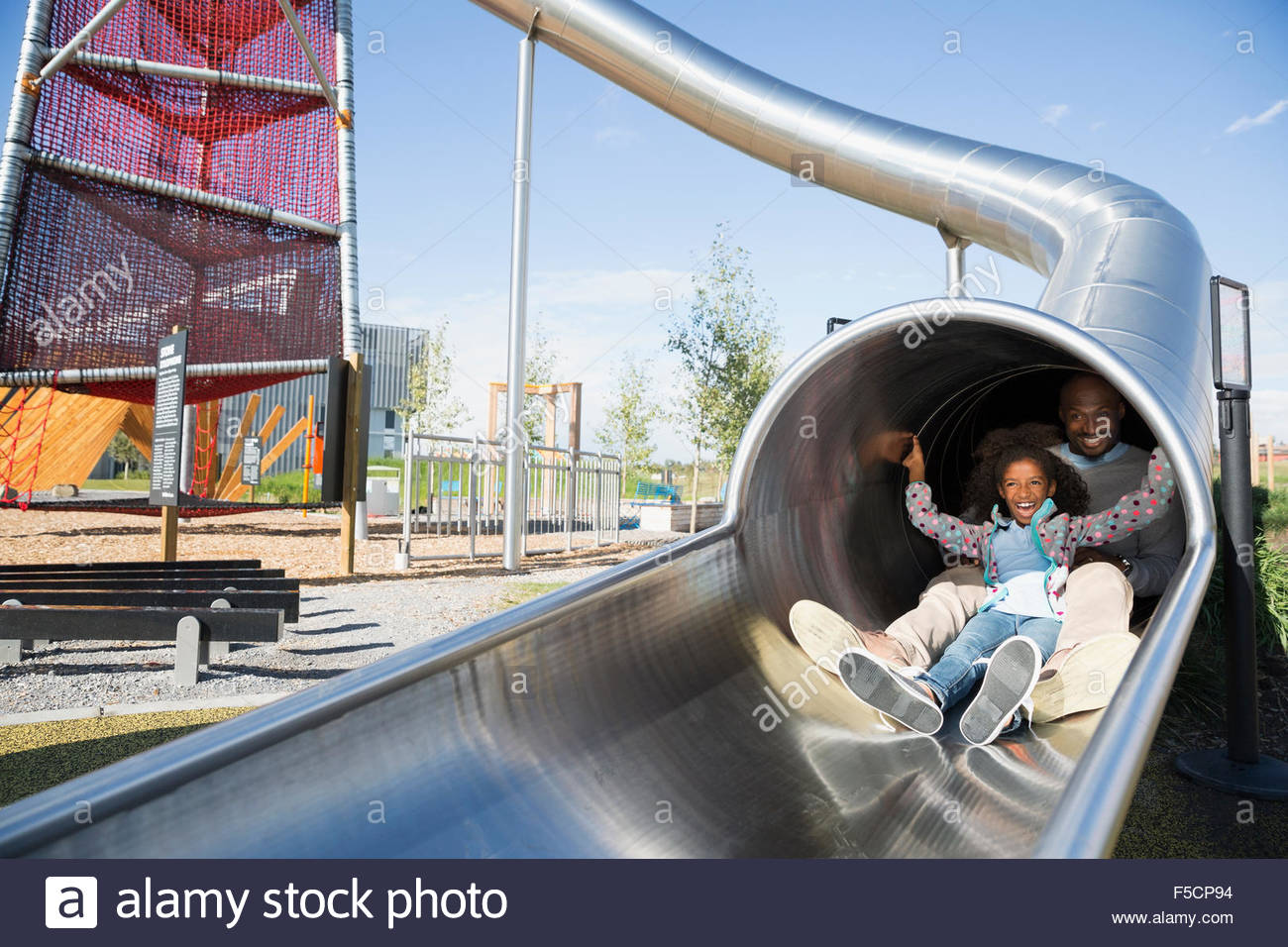 Playground slide man sitting hi-res stock photography and images - Alamy