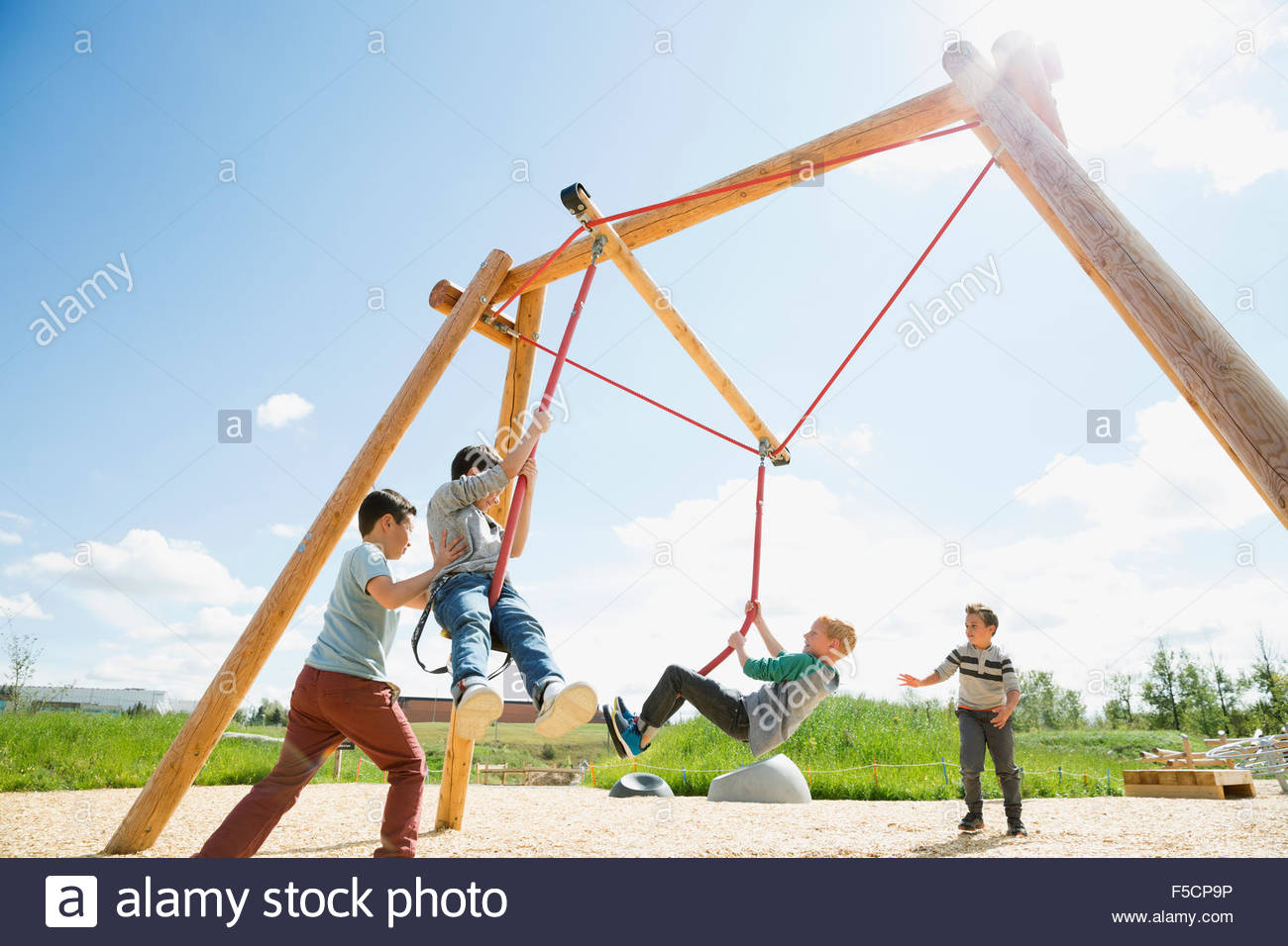 Candid child on rope swing hi-res stock photography and images - Alamy