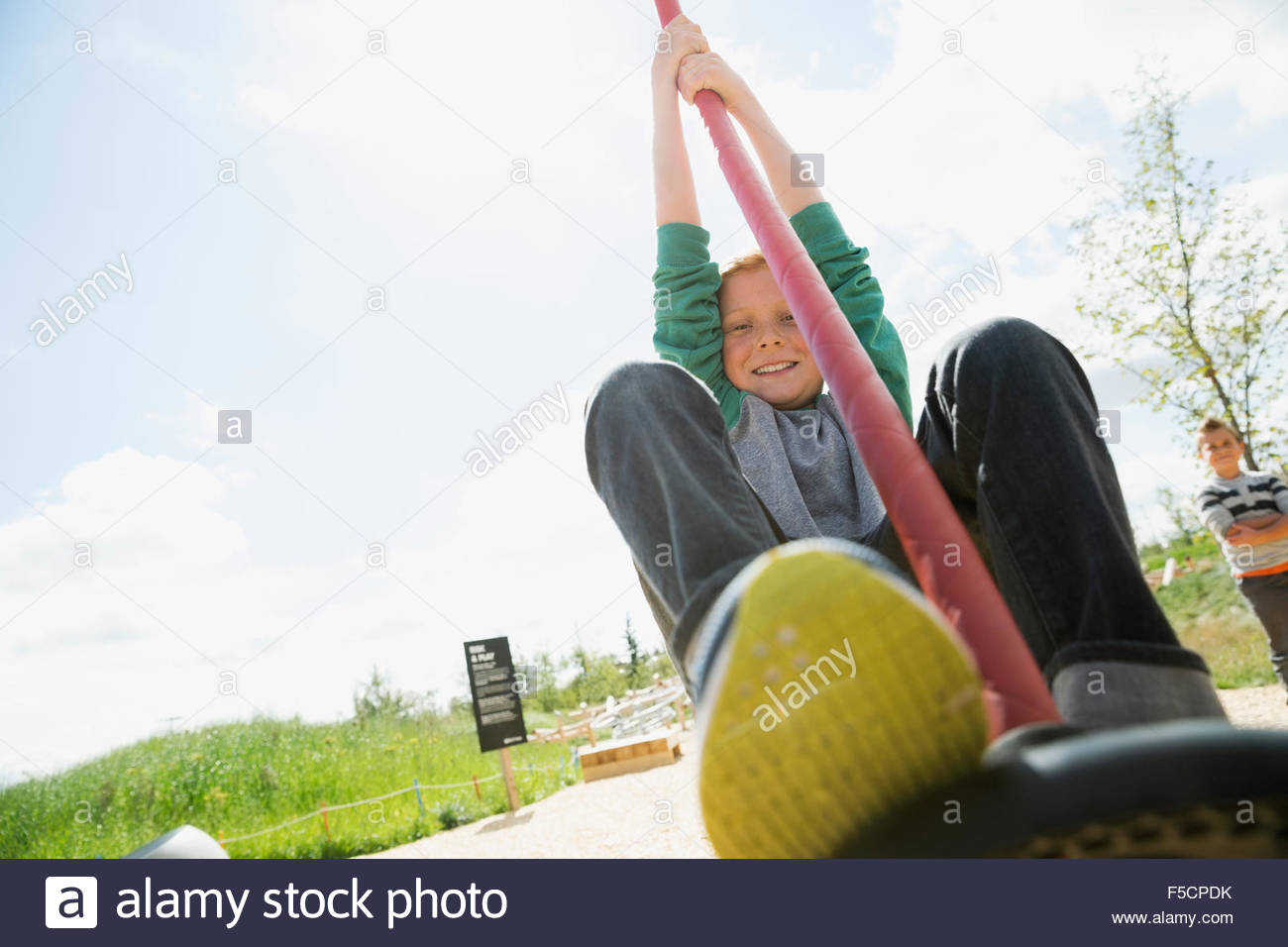 Candid child on rope swing hi-res stock photography and images - Alamy