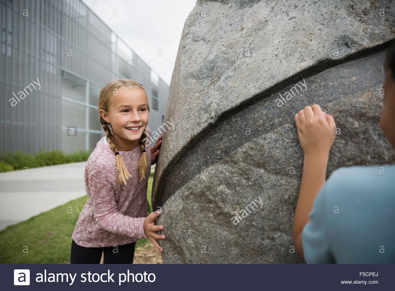 Boy and girl on large rock hi-res stock photography and images - Alamy