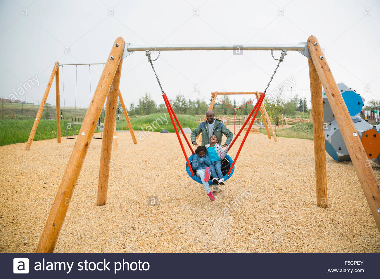 Parent pushing child swing hi-res stock photography and images - Alamy