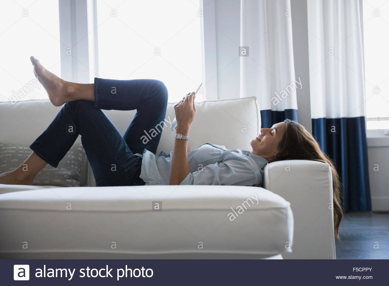 Woman laying sofa hi-res stock photography and images - Alamy