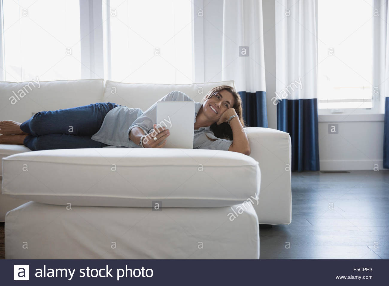 Woman laying sofa hi-res stock photography and images - Alamy