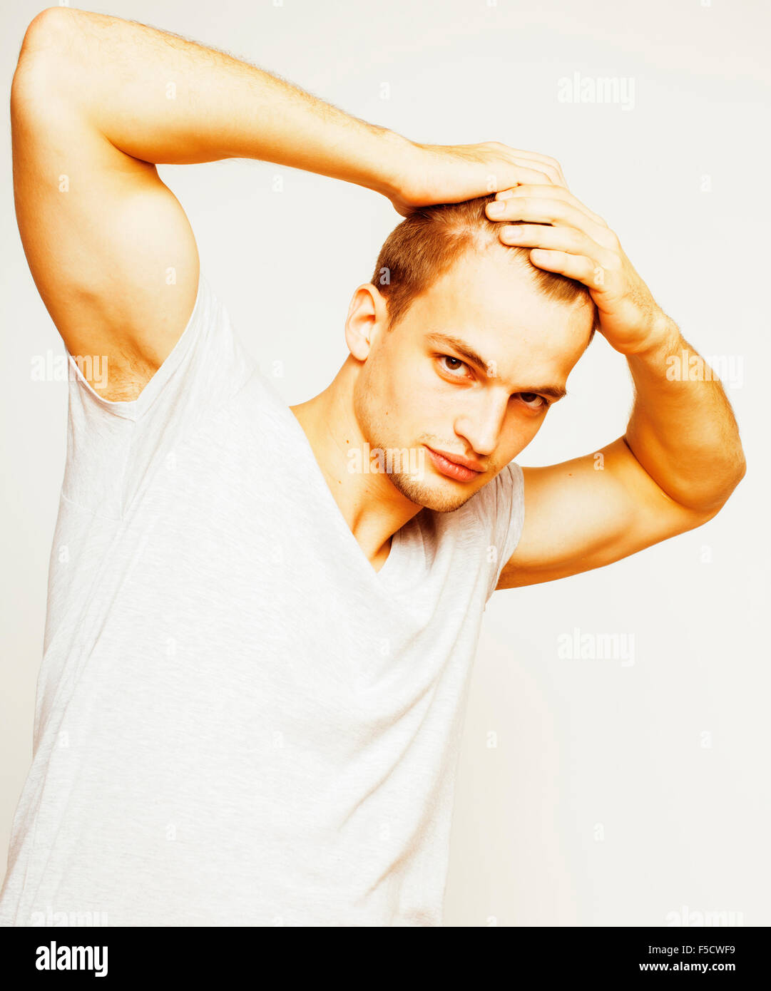 young handsome man on white background gesturing, pointing, posing ...