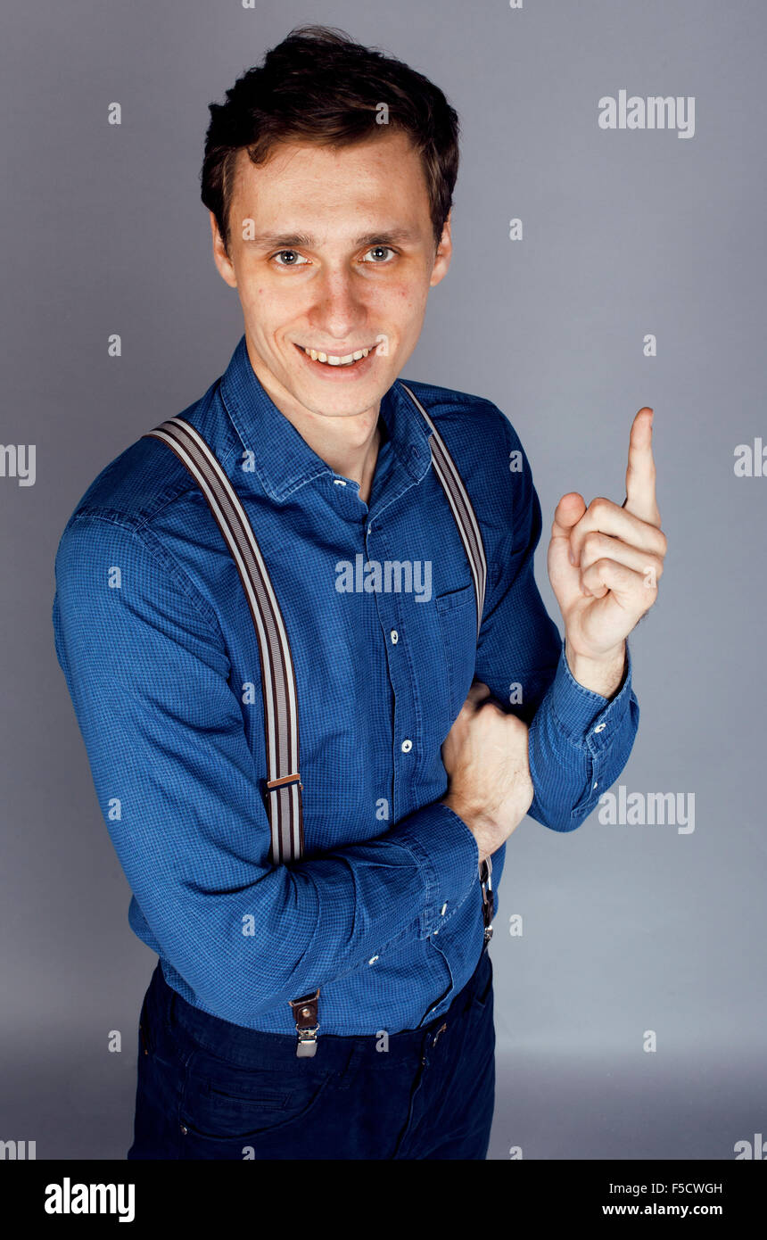 young goofy man with pimples pointing in studio Stock Photo - Alamy