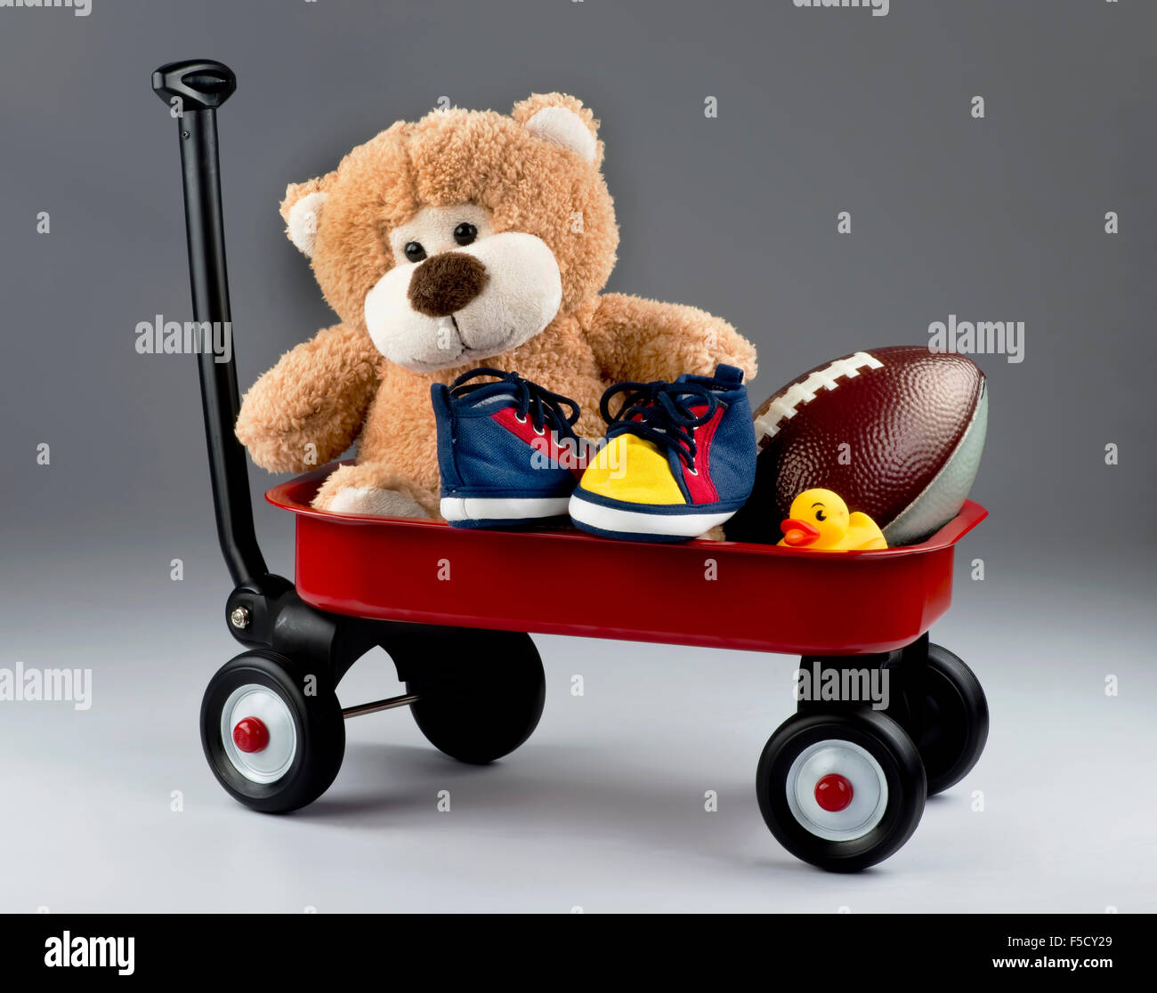 Red wagon full of kids favorite toys Stock Photo - Alamy