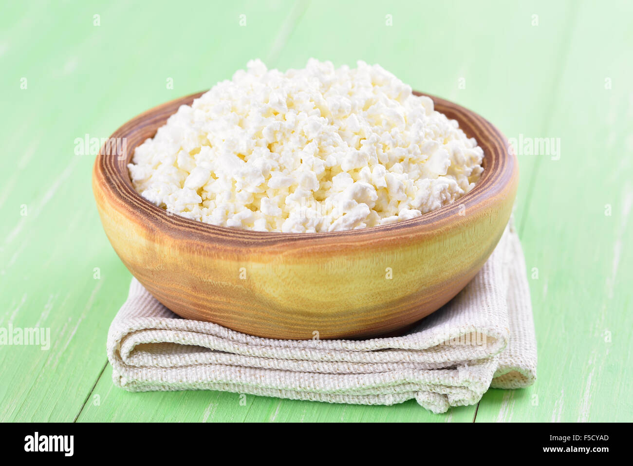Curd in wooden bowl , close up view Stock Photo - Alamy