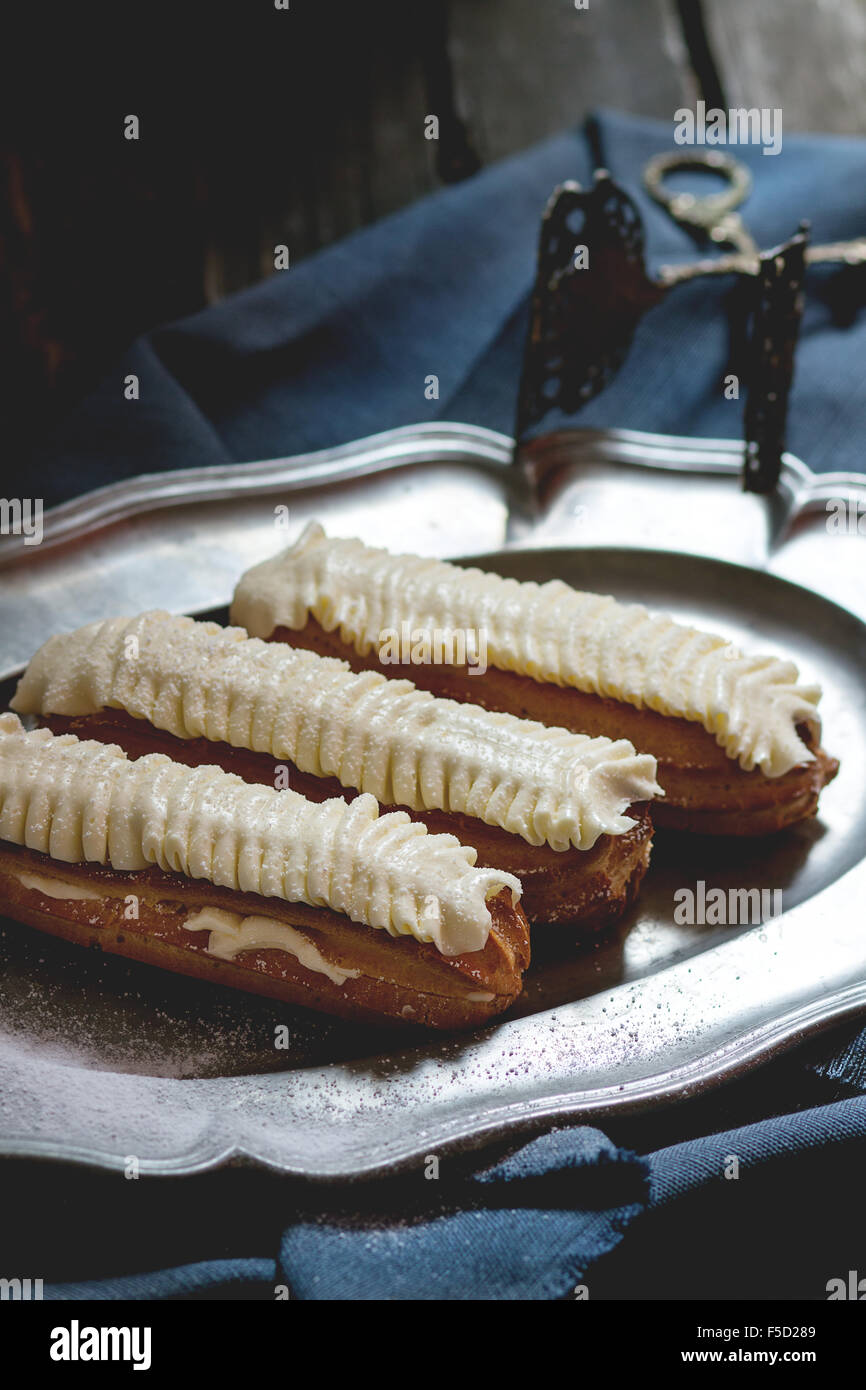 Eclairs in metal plate Stock Photo - Alamy
