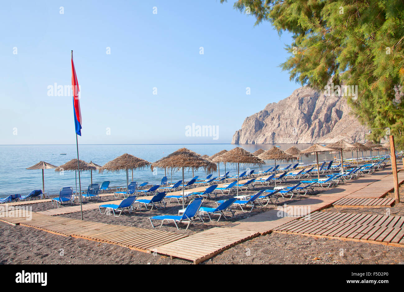 Kamari beach bathing in morning sunlight. Santorini, Greece Stock Photo ...