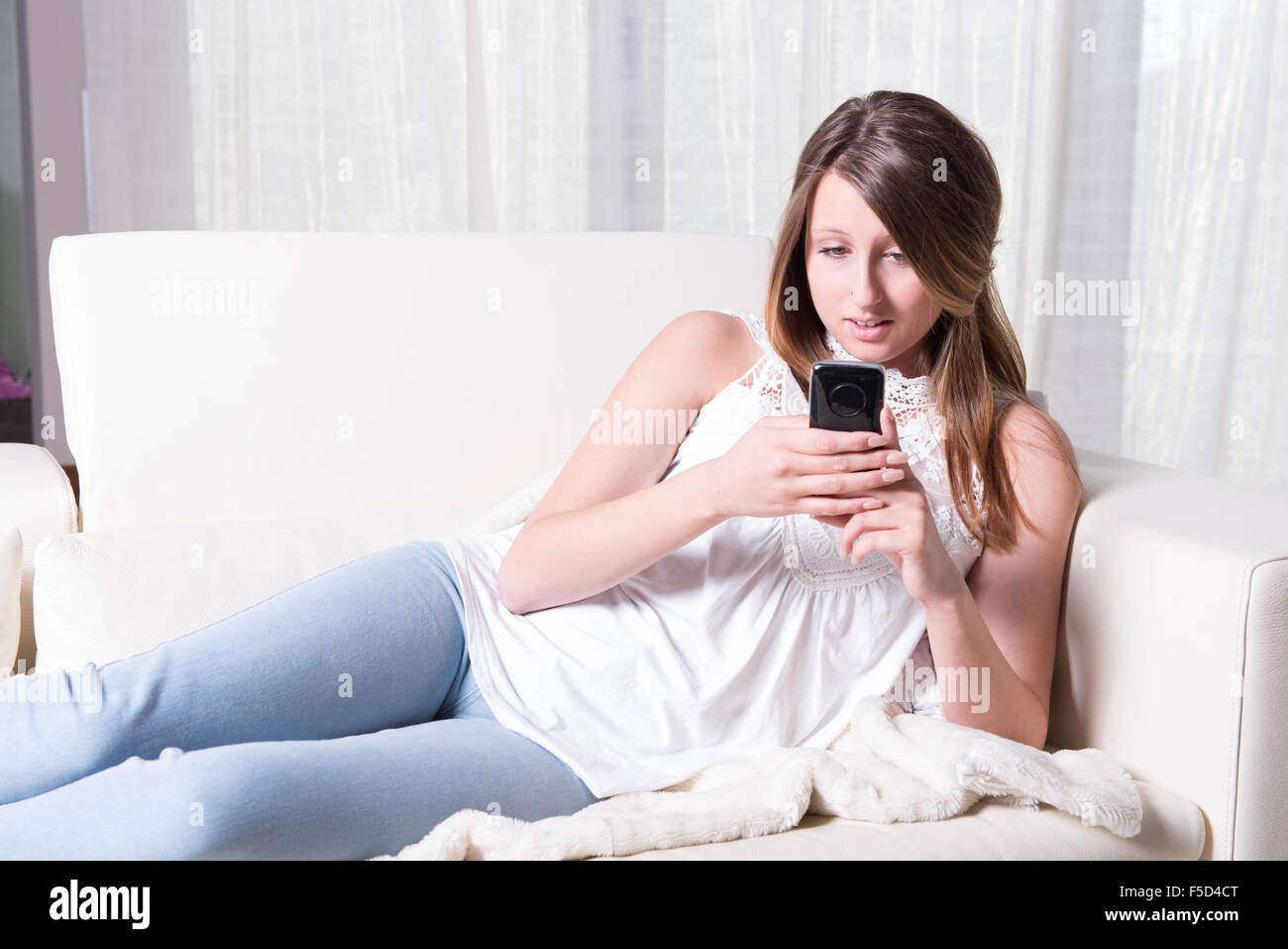 attractive young girl reading a scary message on smartphone Stock Photo ...