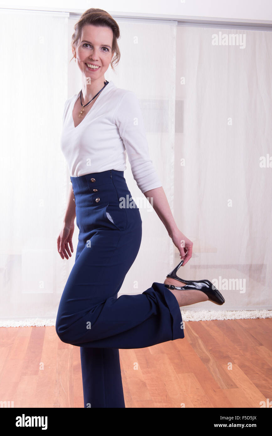 attracative woman holding her leg up Stock Photo - Alamy