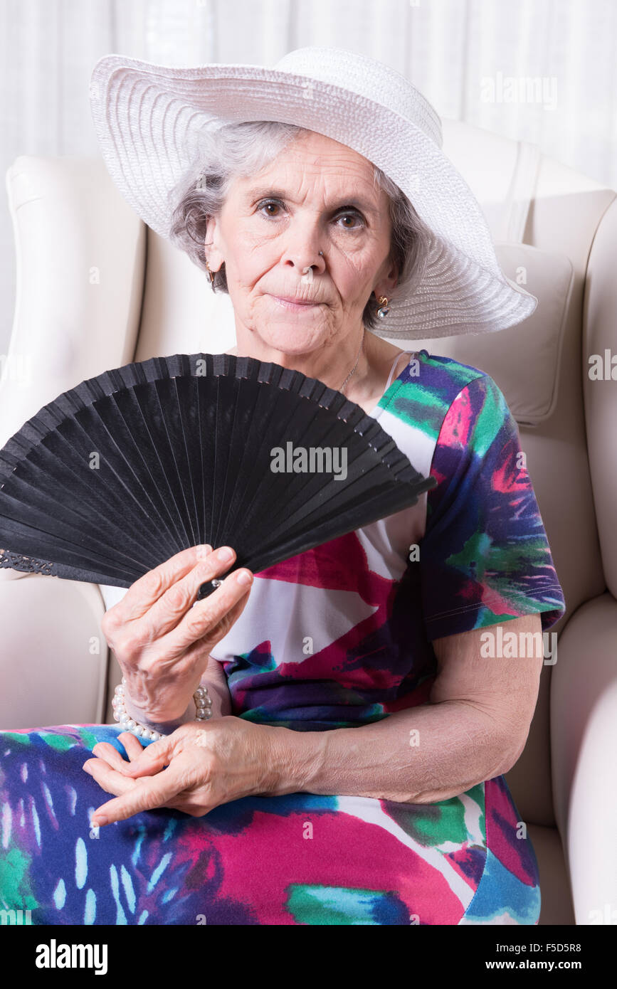 active female senior with fan in her hand Stock Photo - Alamy