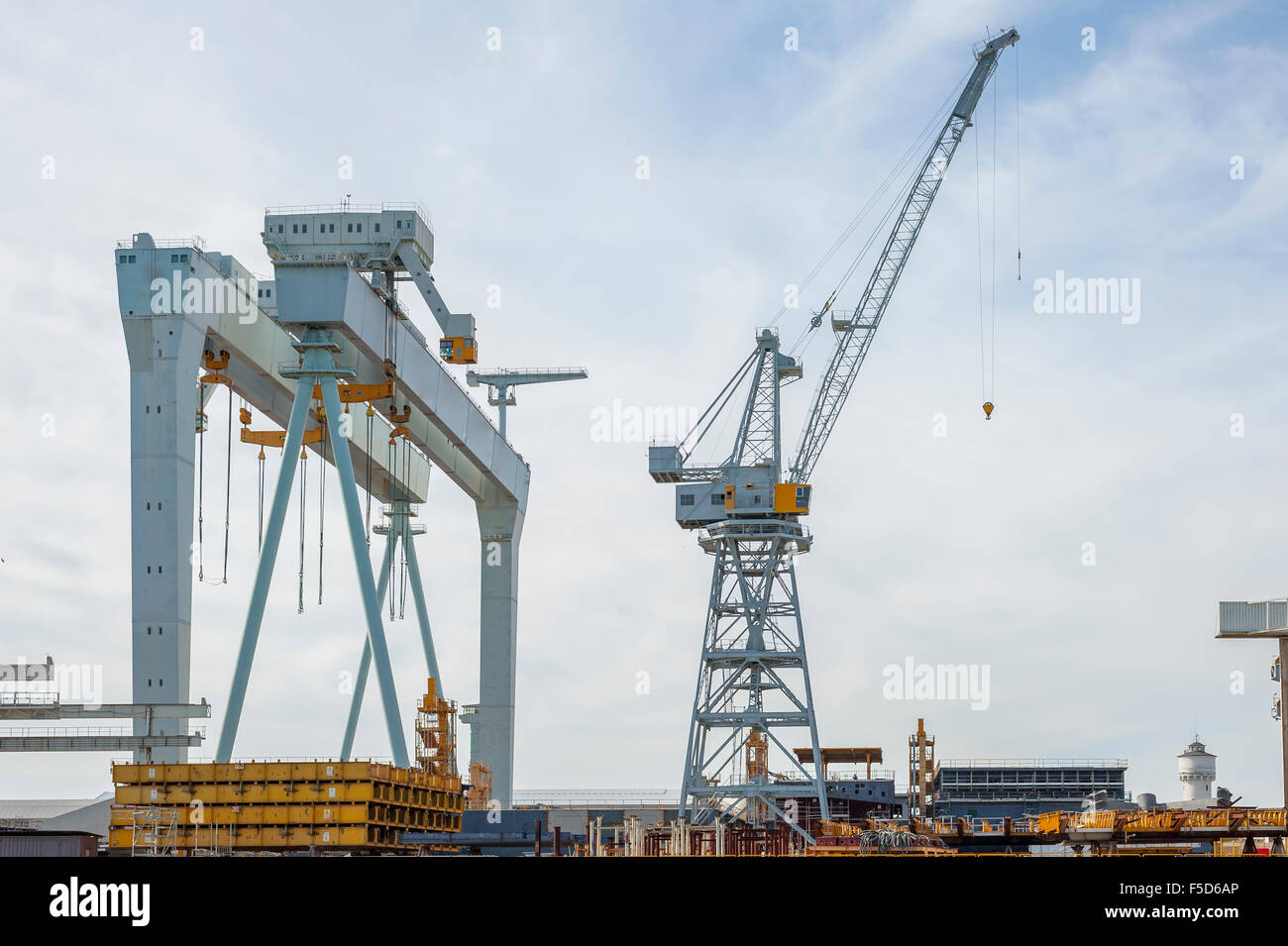 Various types of cranes at work in a shipyard Stock Photo - Alamy