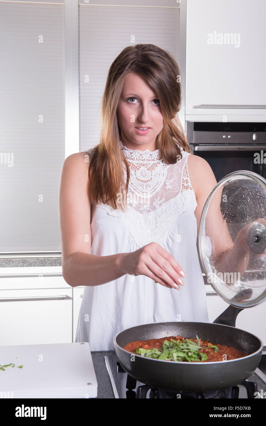young woman cooking spaghetti bolognese Stock Photo - Alamy