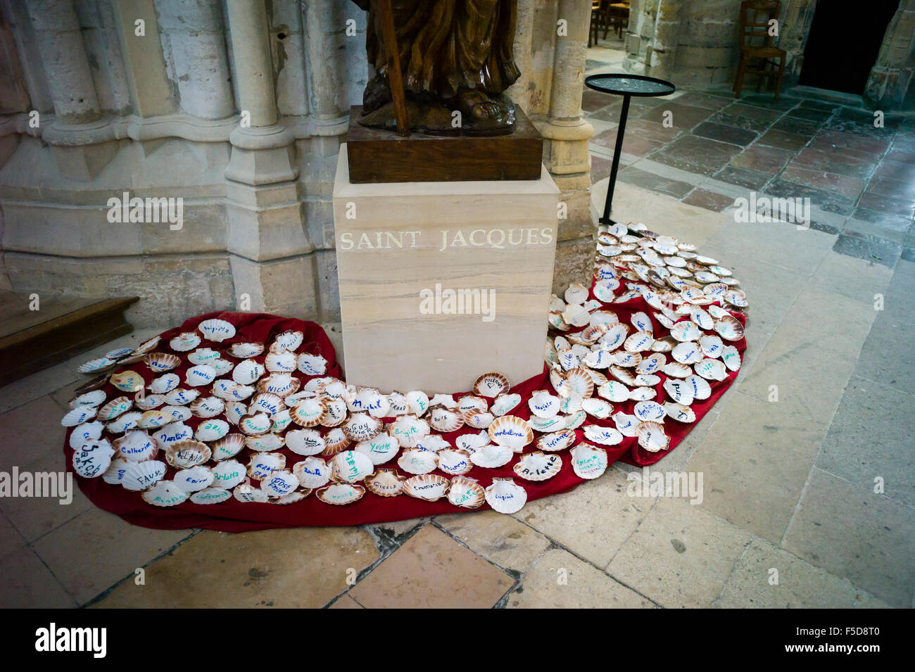 Scallop shells with the names of pilgrims on them laid at the feet of a ...