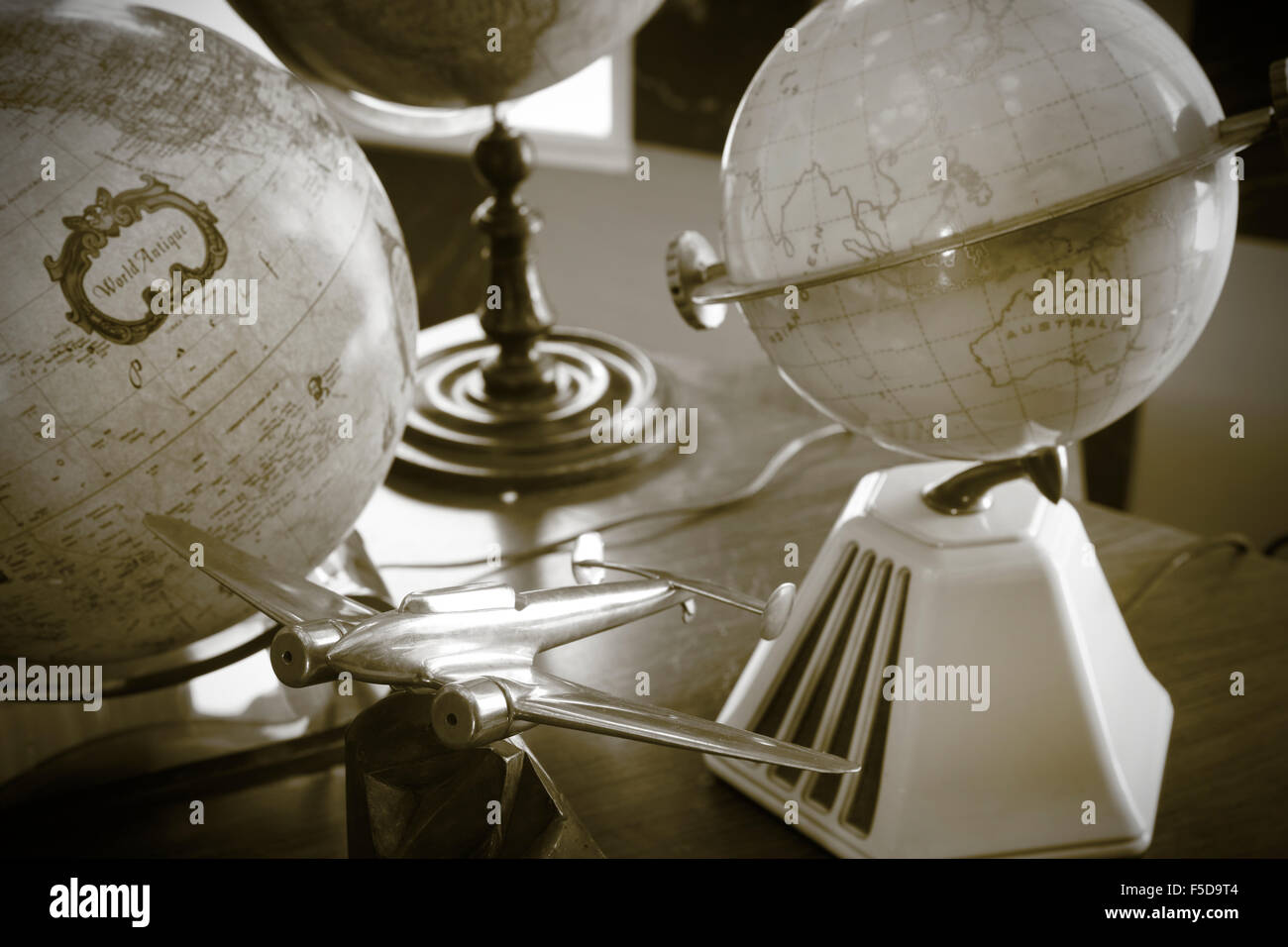 Three antique globes and an airplane scale model be tone Stock Photo ...