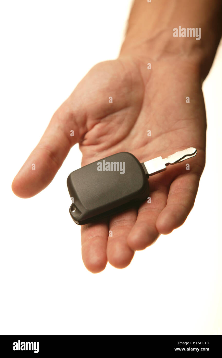 Car key on human hand easy isolated on white vertical Stock Photo - Alamy