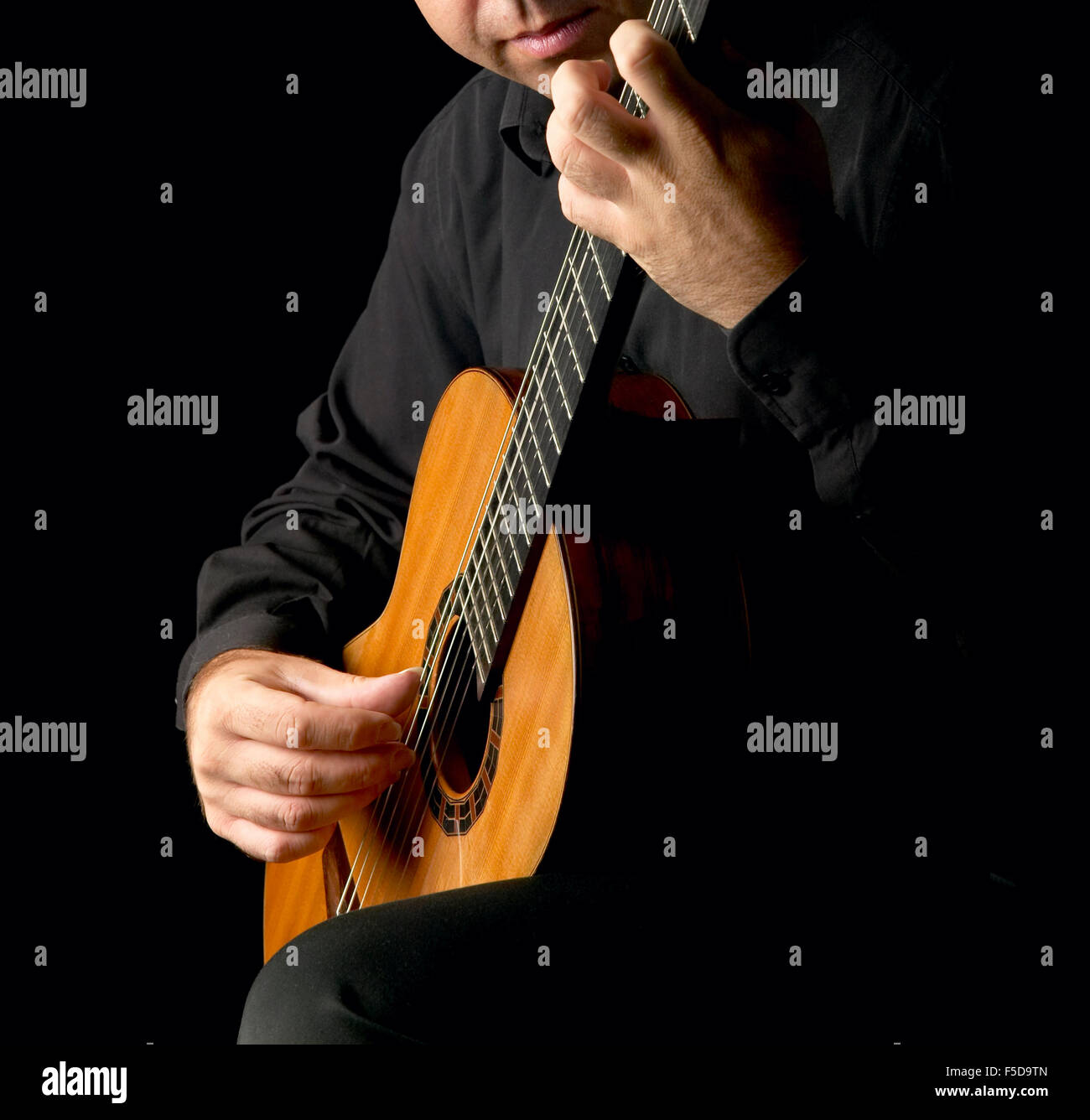 Classical Guitarist low key image square format Unrecognizable person ...