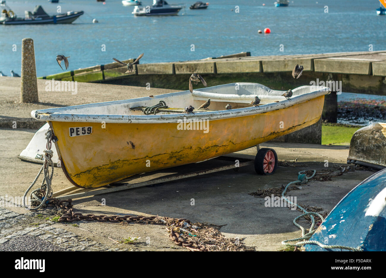 Small boat with starlings in flight at Christchurch Harbour ...