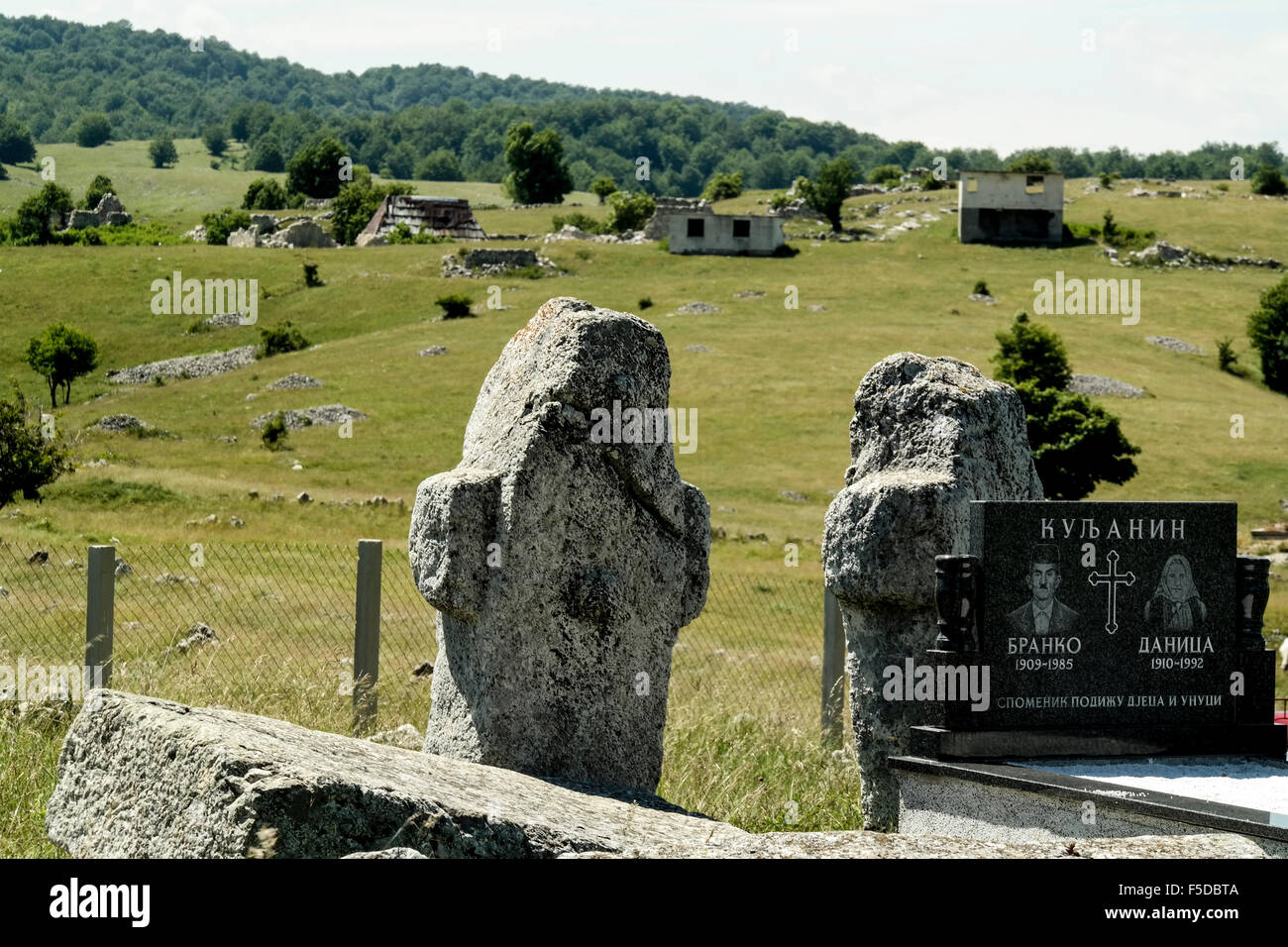Stećci (medieval gravestones), modern graves and destroyed houses in ...