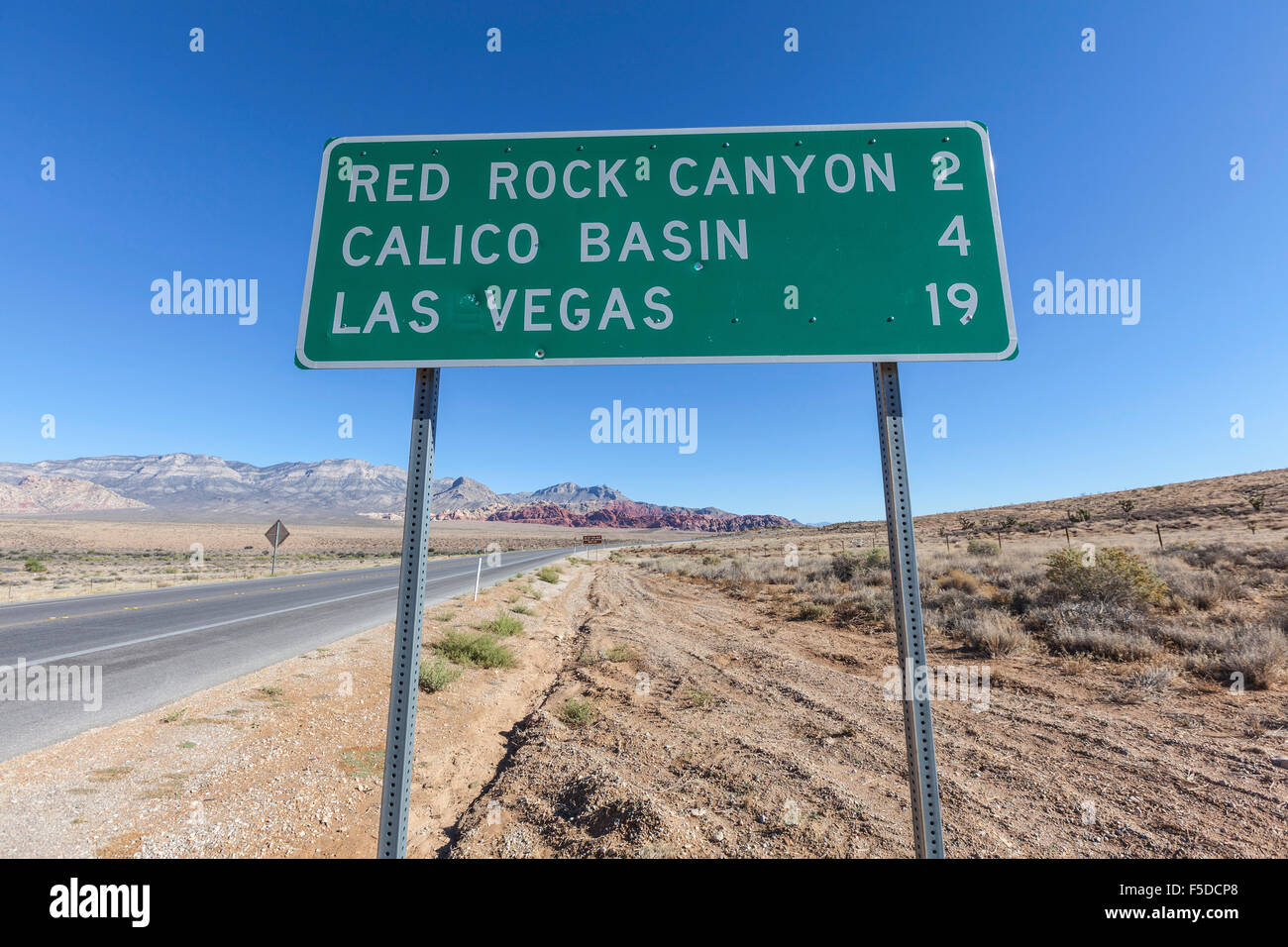 Las Vegas and Red Rock Canyon highway sign with bullet holes Stock ...