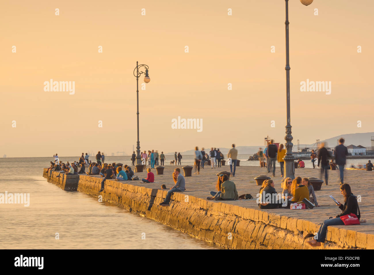 Trieste harbor, view at sunset of people enjoying an evening ...