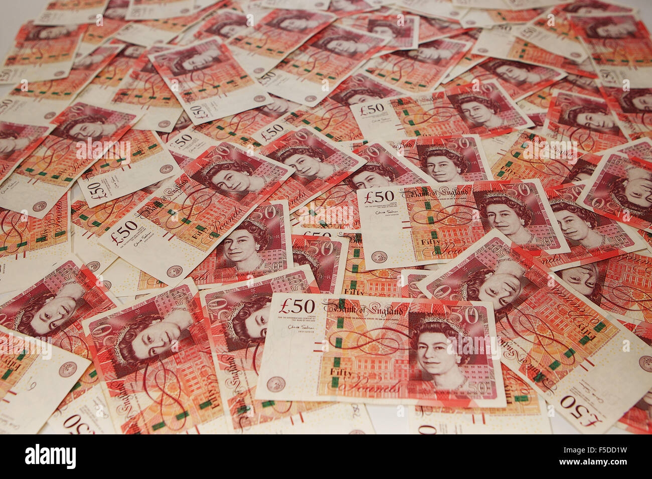 Pile of £50 notes spread out Stock Photo - Alamy