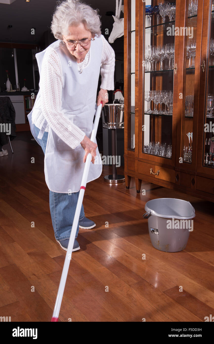active female senior cleaning the floor Stock Photo - Alamy