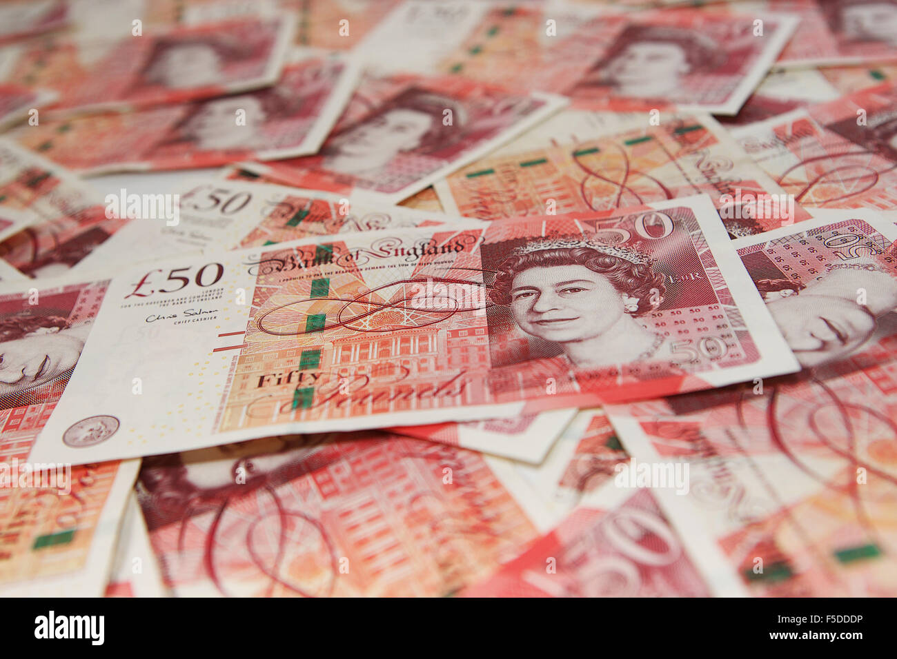 Pile of £50 notes spread out Stock Photo - Alamy