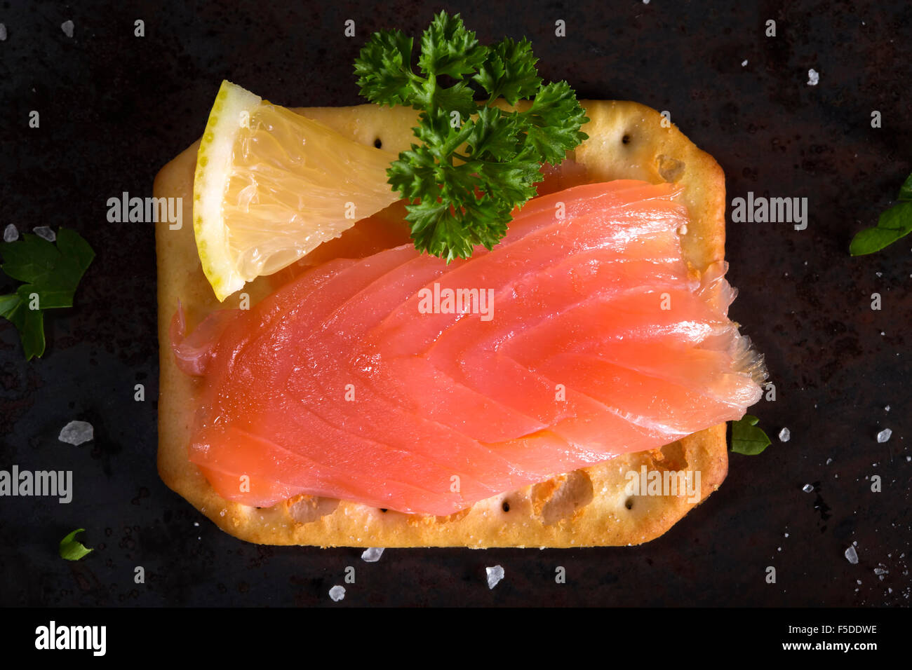 Close-up of smoked salmon served with crackers Stock Photo - Alamy