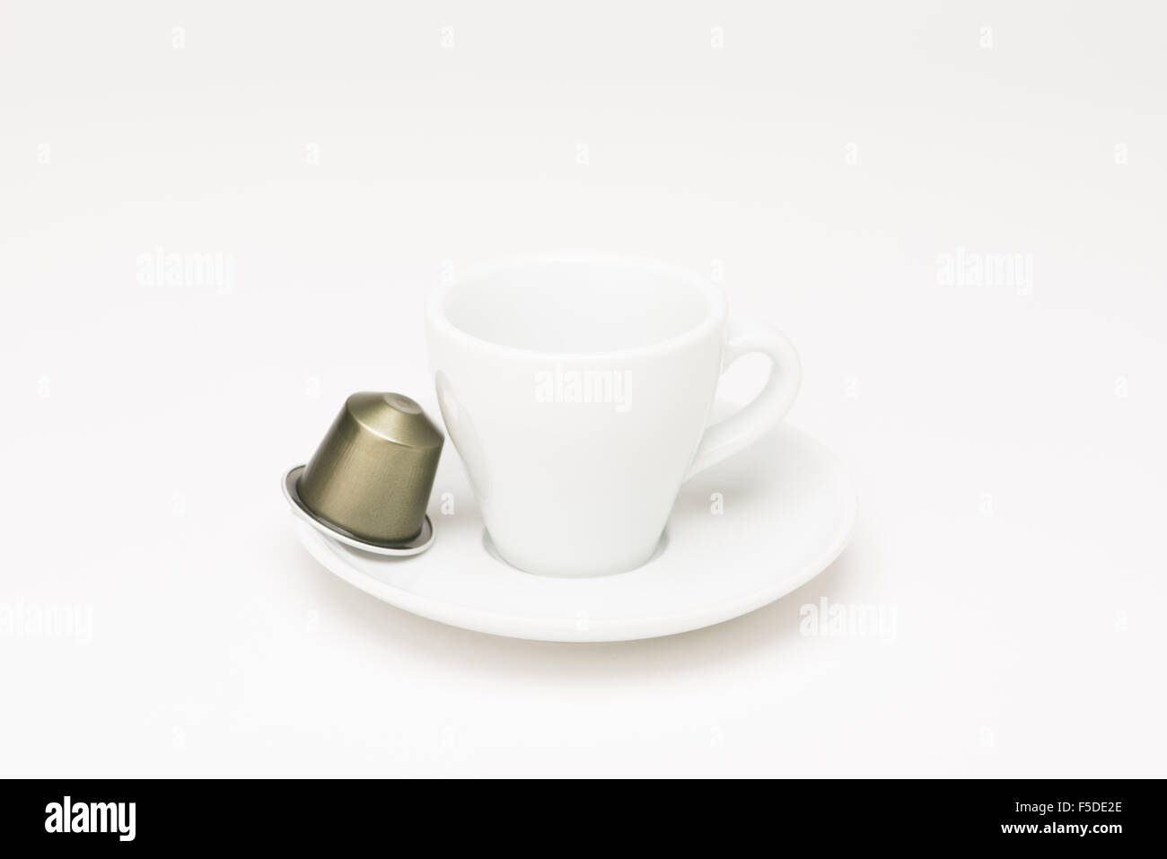 Coffee cup with capsule isolated on white Stock Photo - Alamy