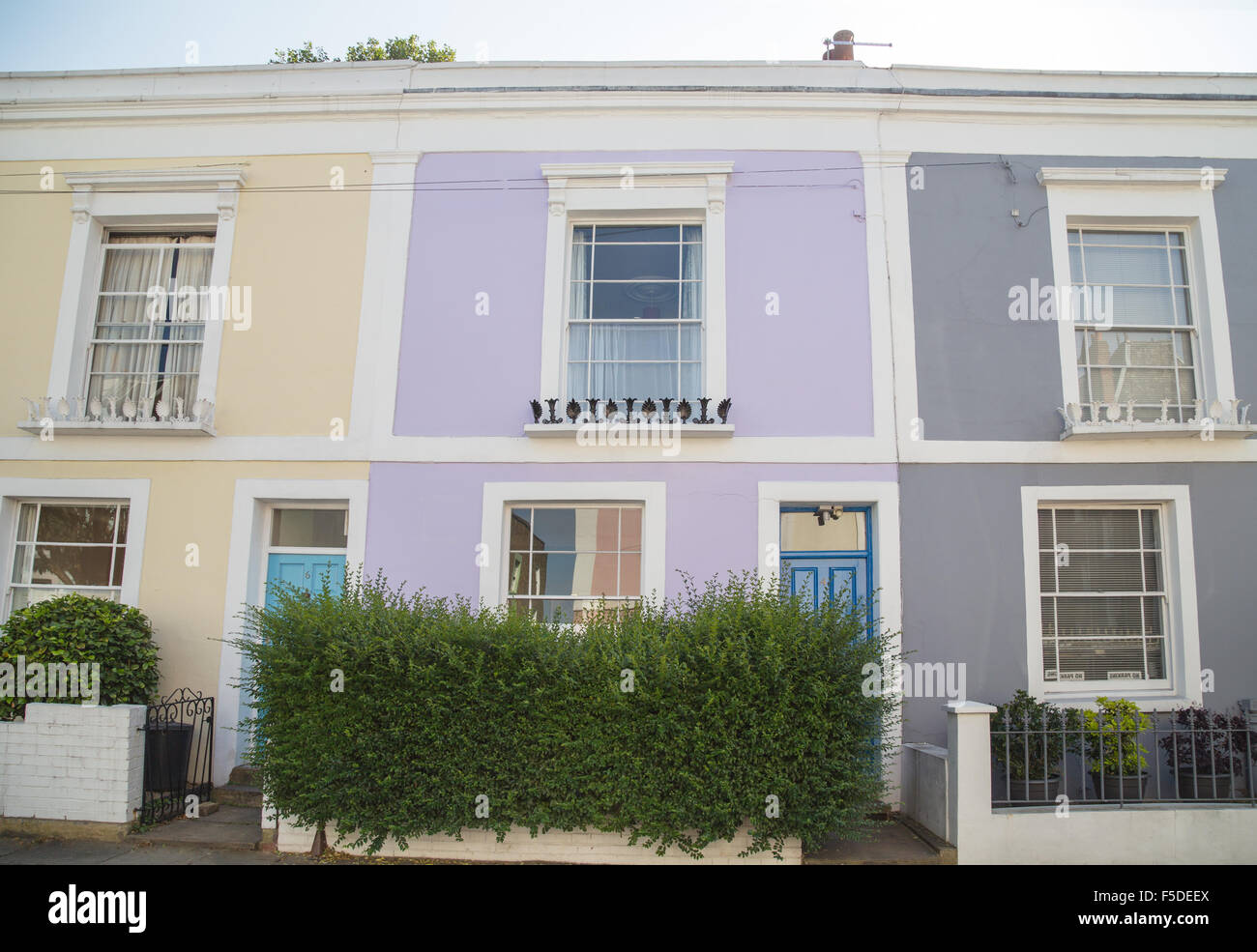 Colourfully painted terraced houses on Leverton Street, Kentish Town ...