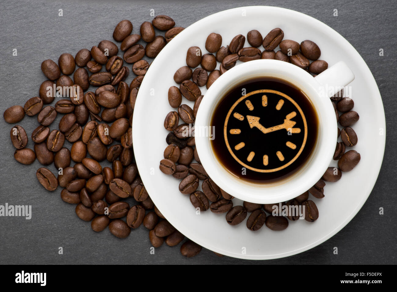 Cup of coffee with time and bean Stock Photo - Alamy
