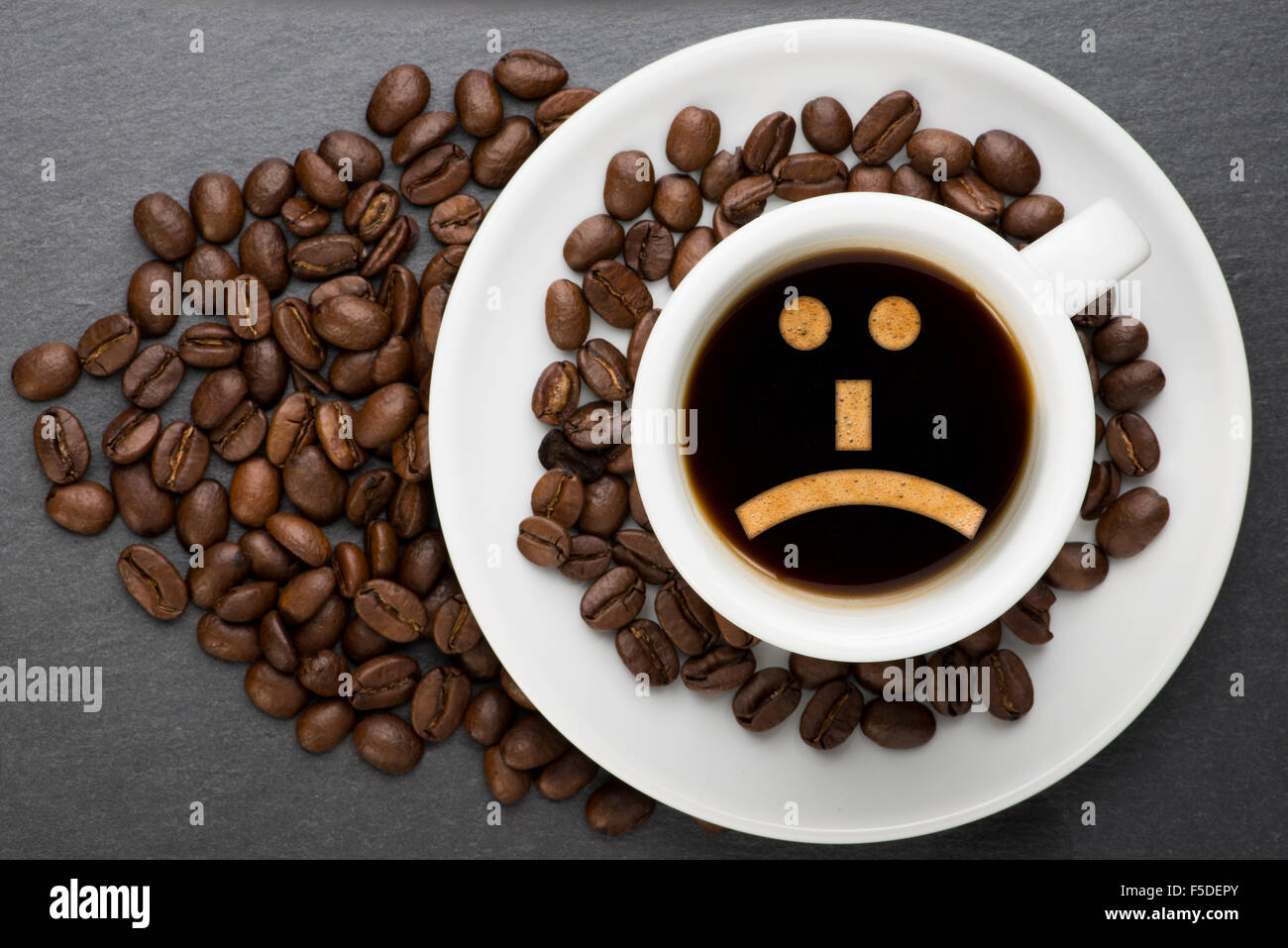 Cup of coffee with sad with bean Stock Photo - Alamy