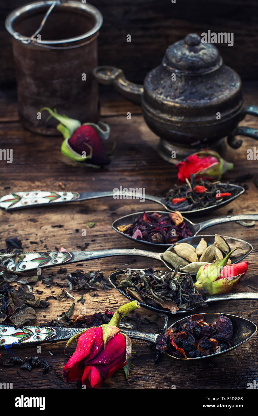 Dried tea leaves in spoons on stylish background of the teapot Stock ...