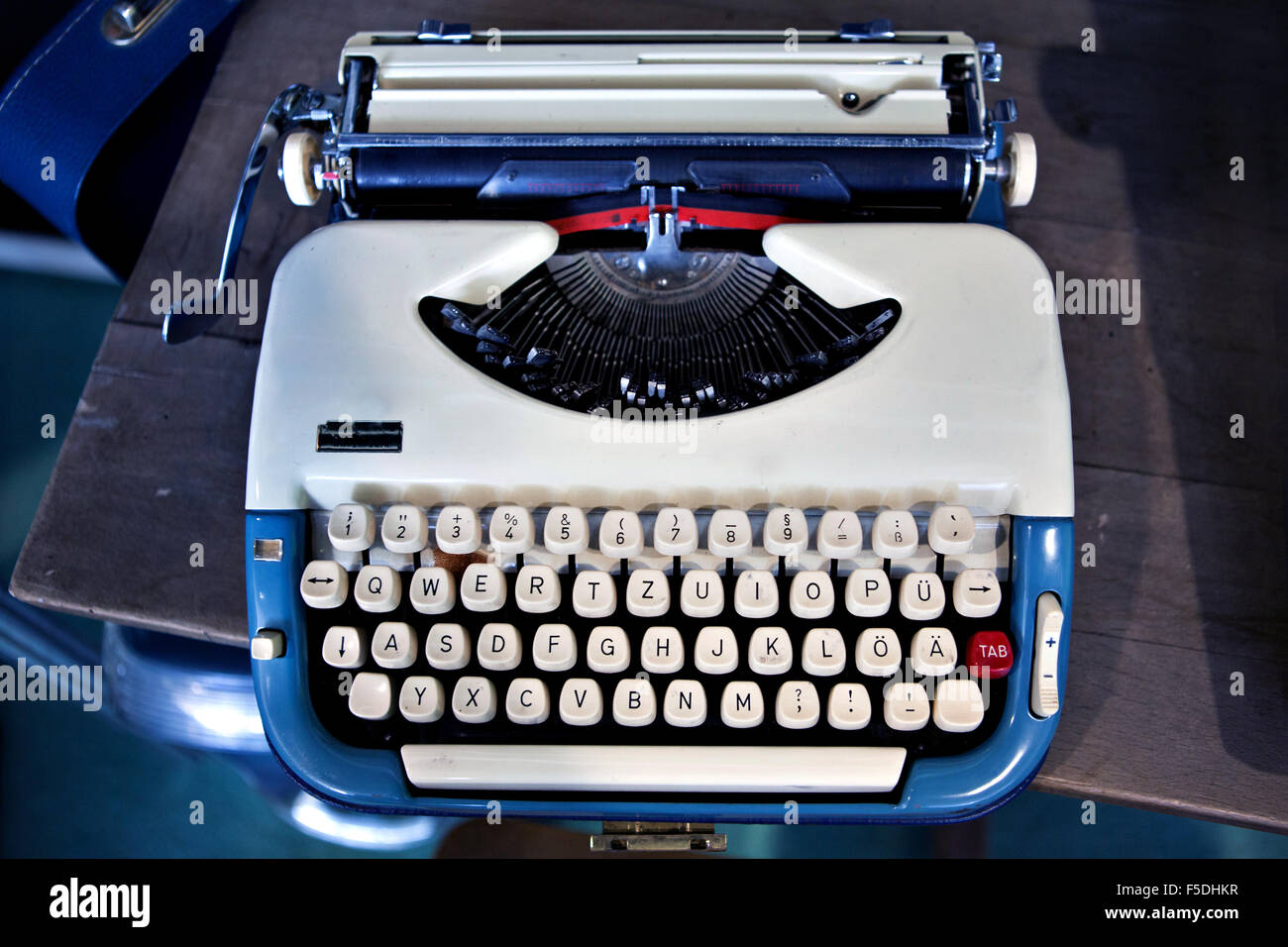 Old fashioned blue, white typewriter Stock Photo - Alamy