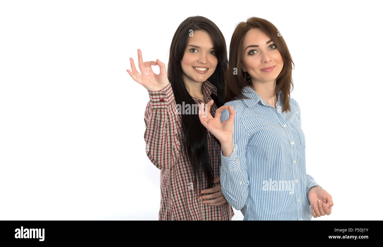 Two cheerful girls makes OK hand sign Stock Photo - Alamy