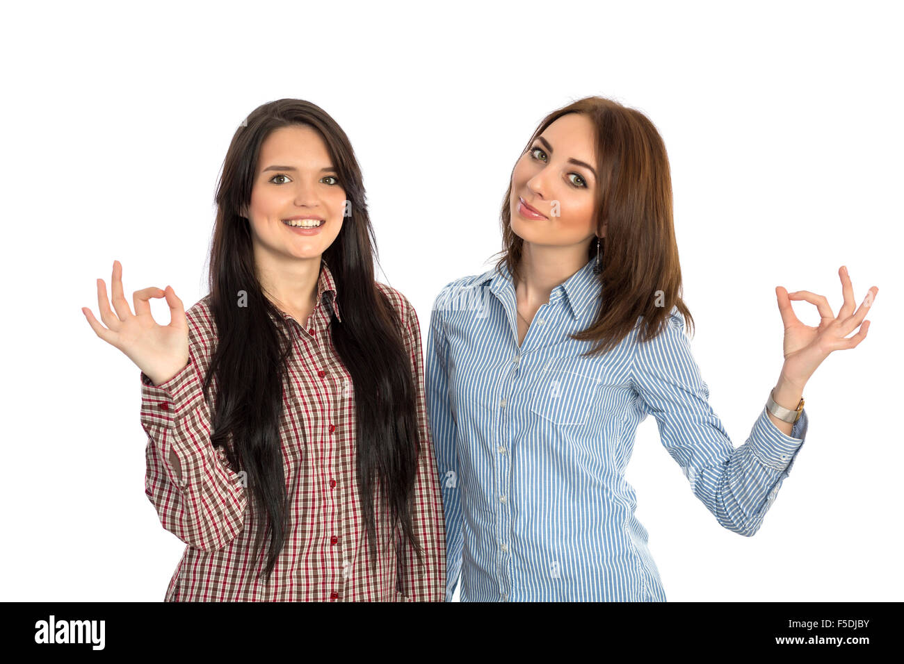 Two cheerful girls makes OK hand sign Stock Photo - Alamy