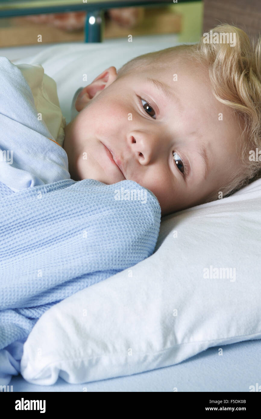 sick little boy in a hospital bed Stock Photo - Alamy