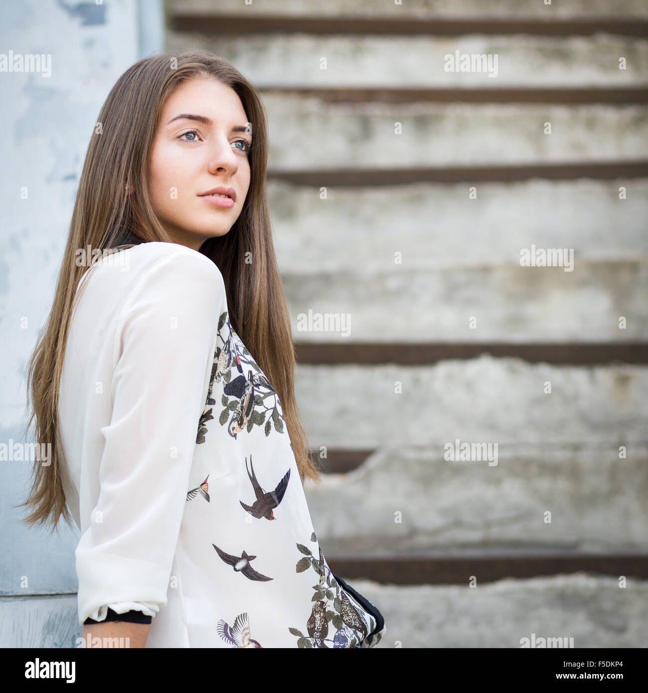 Beautiful adult girl standing on stairs and looking straight Stock ...