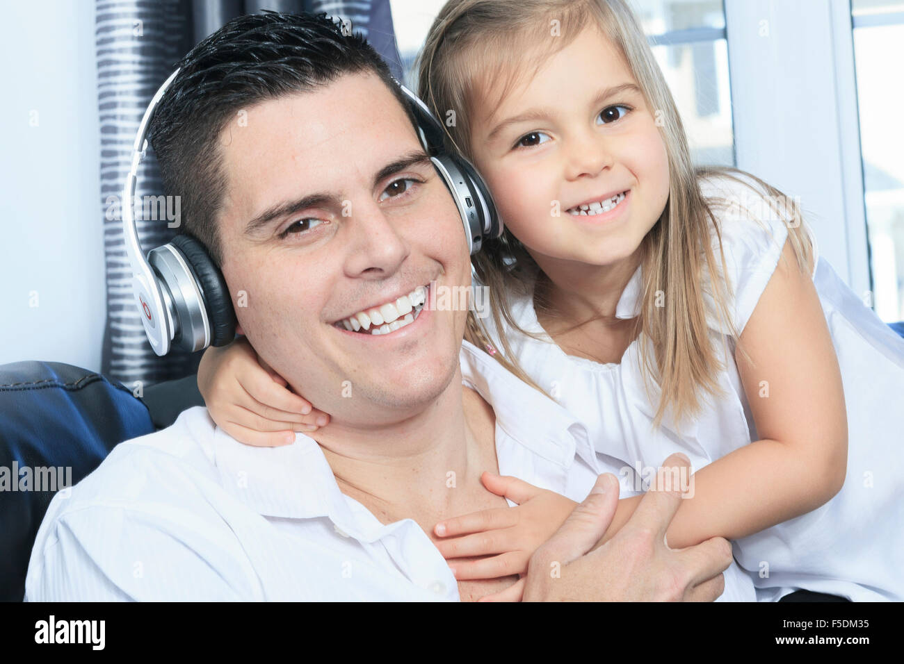 Father and daughter listening to music Stock Photo - Alamy